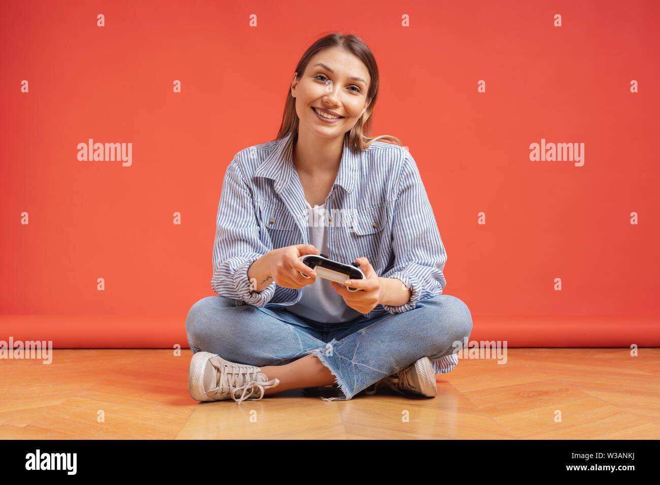 Excited delighted woman playing video games, while holding a game ...