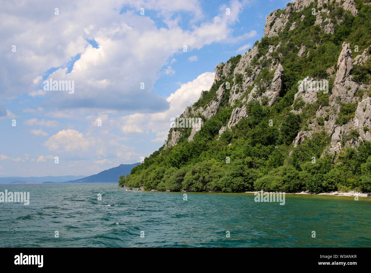 View of the rocks covered in trees on the beautiful Lake Ohrid ...