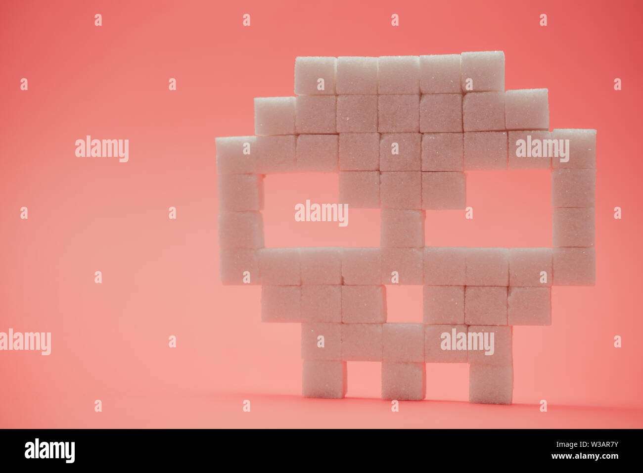 Skull with sugar cubes on a peach background. Concept sweet kill or ...