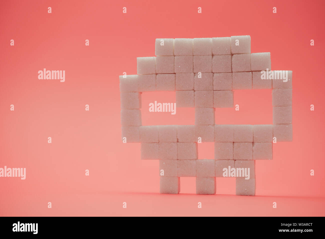 Skull with sugar cubes on a peach background. Concept sweet kill or ...