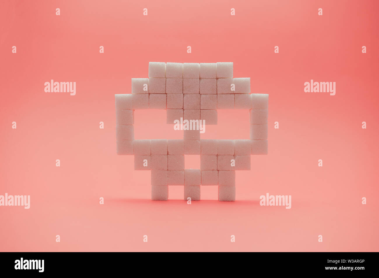 Skull with sugar cubes on a peach background. Concept sweet kill or ...
