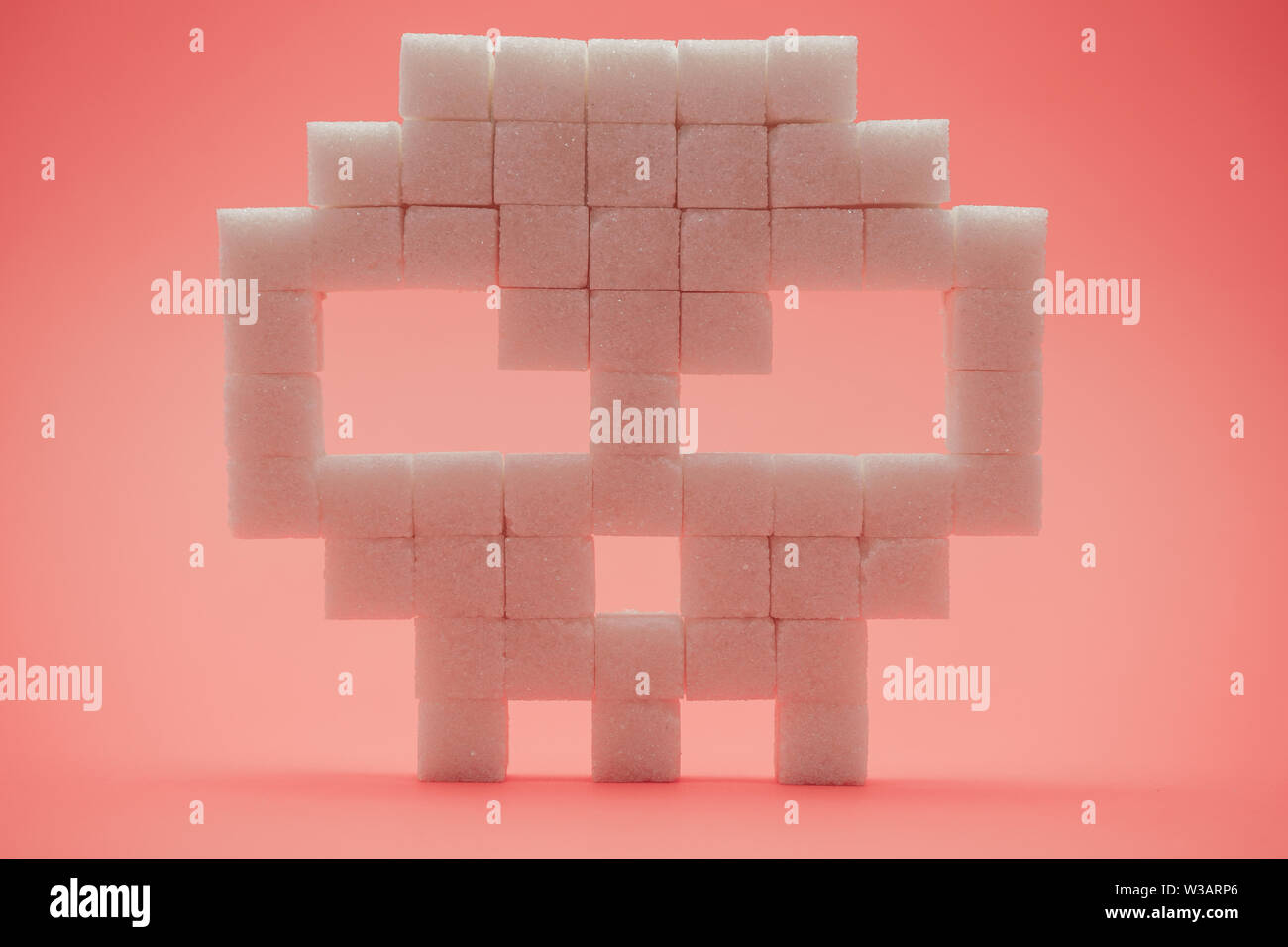 Skull with sugar cubes on a peach background. Concept sweet kill or ...