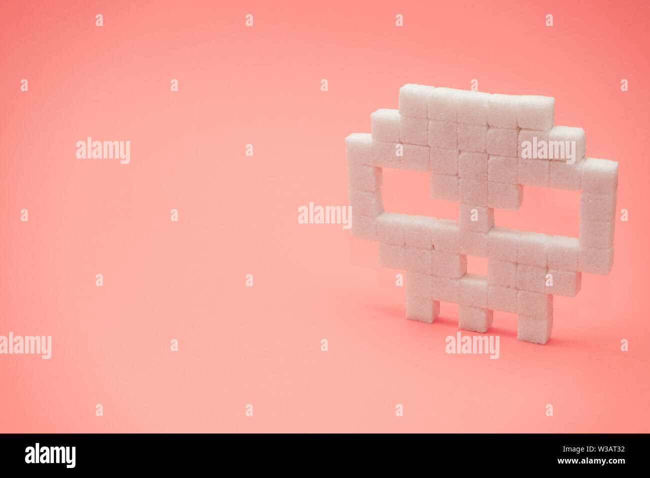 Skull with sugar cubes on a peach background. Concept sweet kill or ...