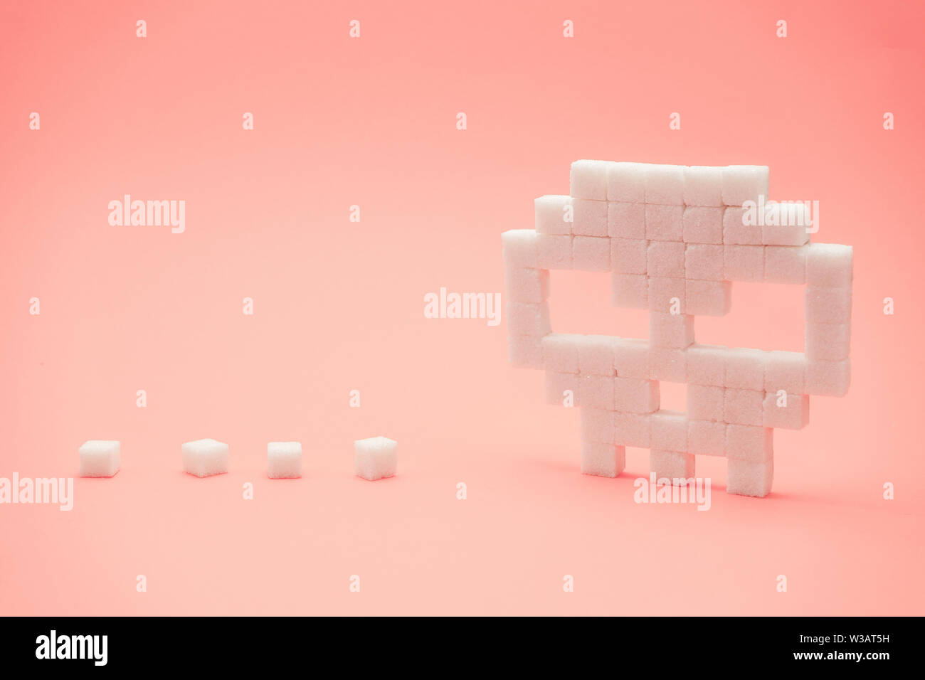 Skull with sugar cubes on a peach background. Concept sweet kill or ...