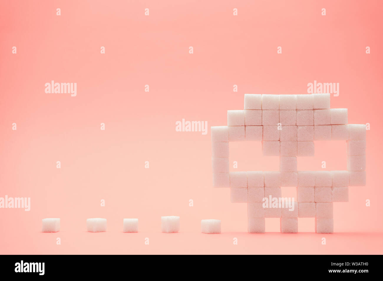 Skull with sugar cubes on a peach background. Concept sweet kill or ...