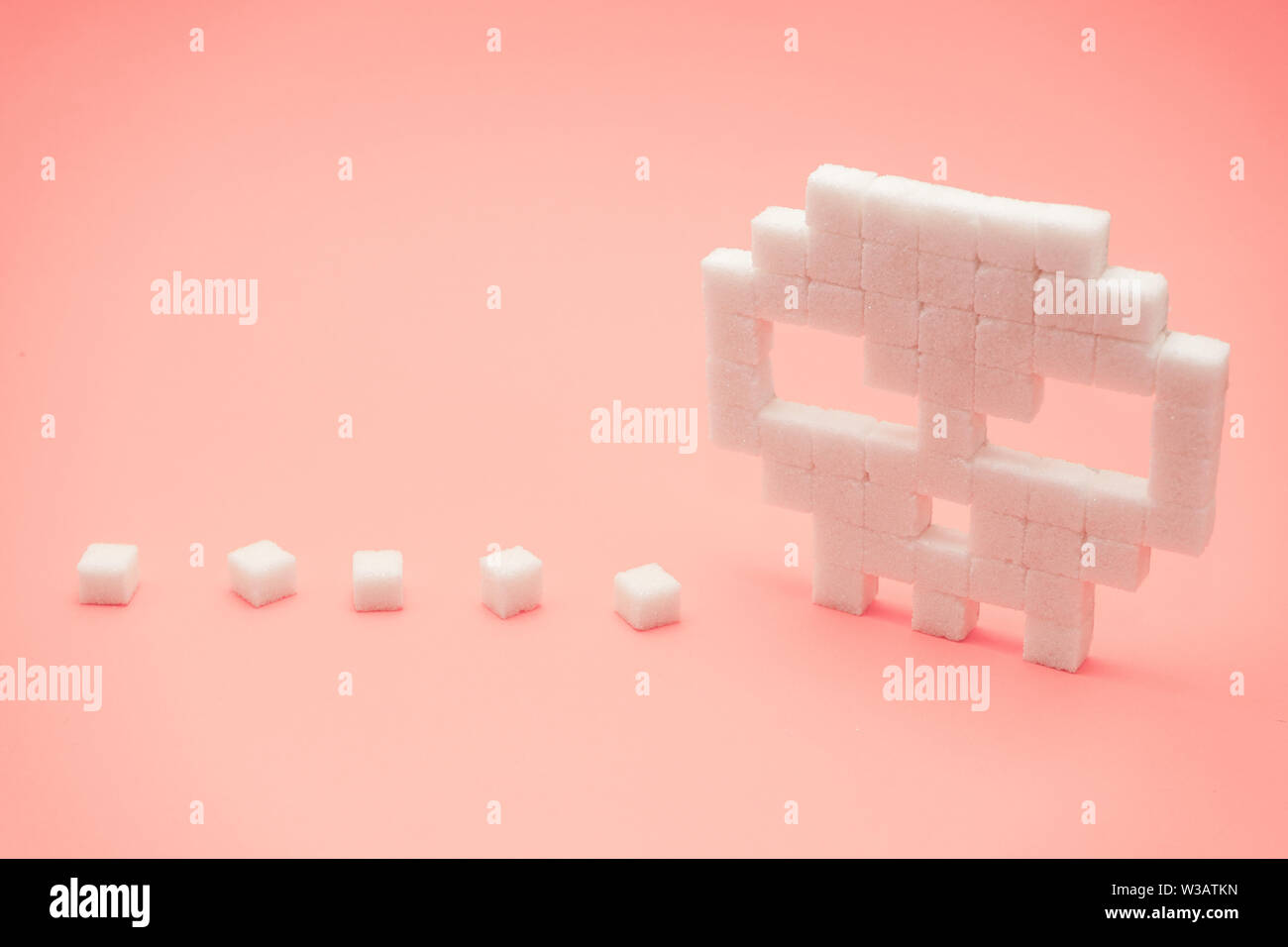 Skull with sugar cubes on a peach background. Concept sweet kill or ...