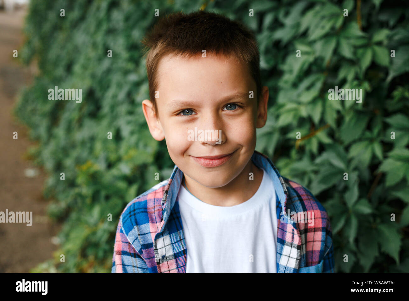 Portrait happy smiling boy wearing a checkered shirt outdoor Stock ...