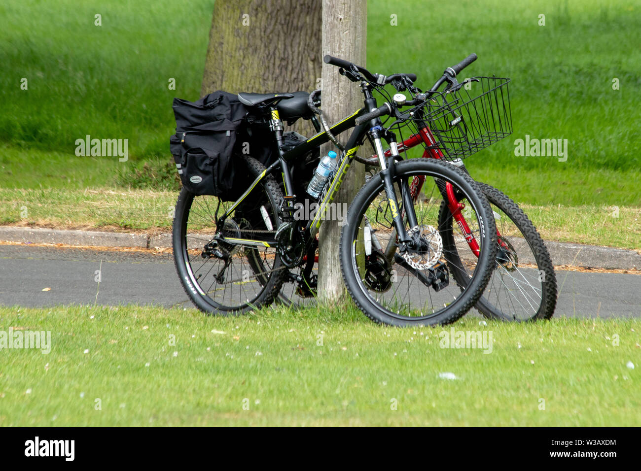 Two bicycles chained to telegraph pole Stock Photo - Alamy