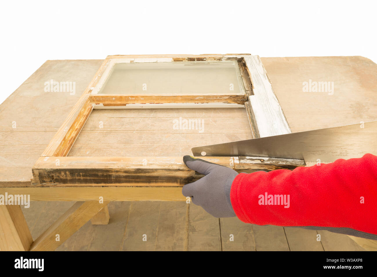 Repairing a window frame. Carpenter using a handsaw for renovation of ...
