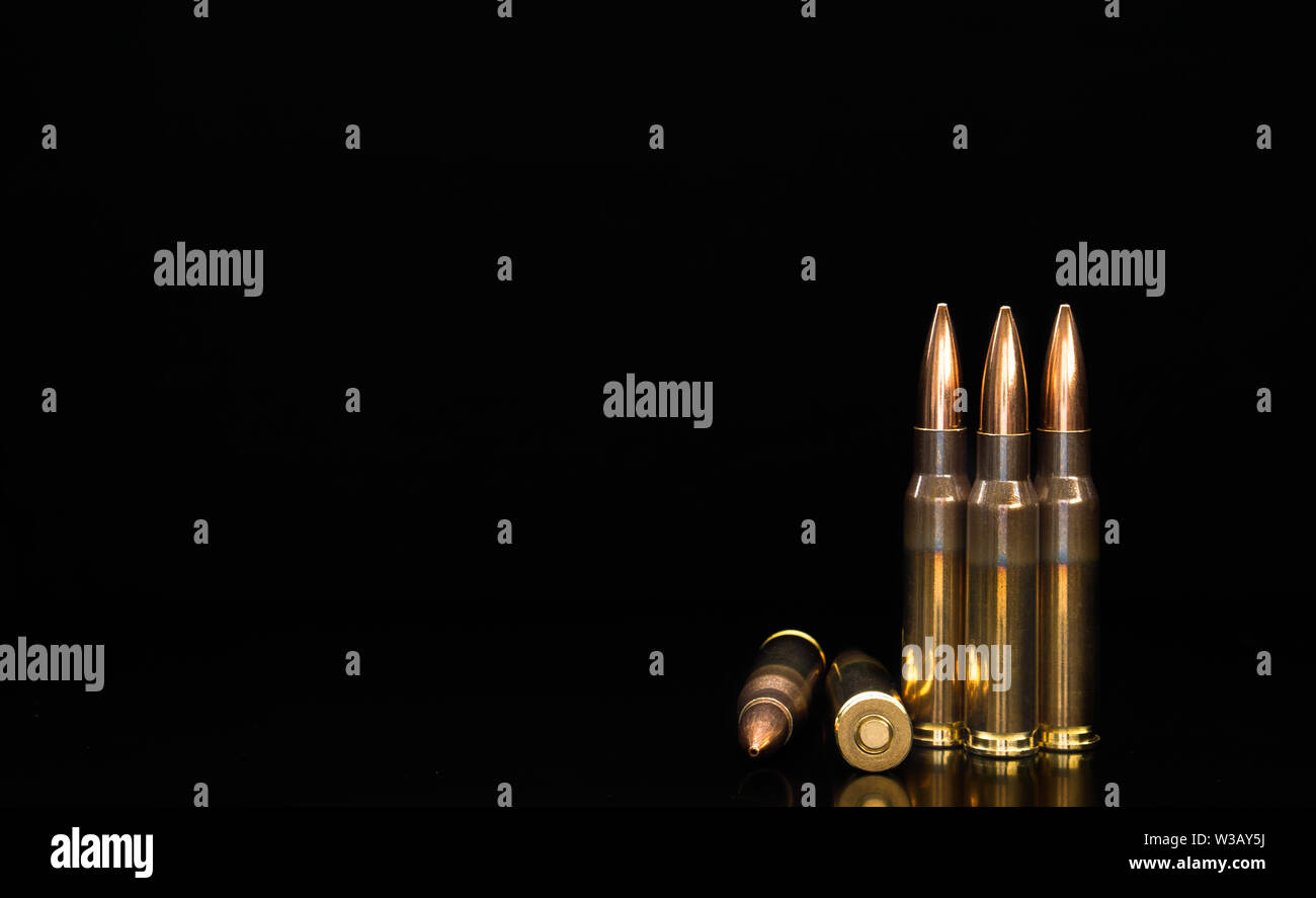 Rifle bullets close-up on black back. Cartridges for rifle and carbine ...