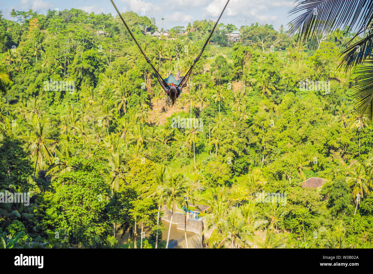 Young woman swinging in the jungle rainforest of Bali island, Indonesia ...