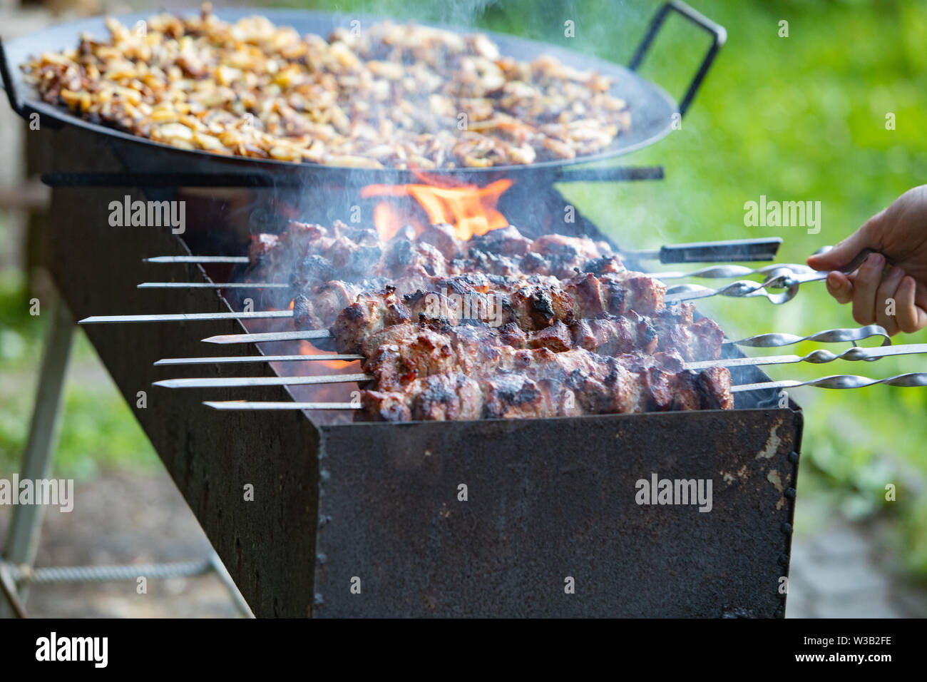 cooking meat at bbq fire close up Stock Photo - Alamy