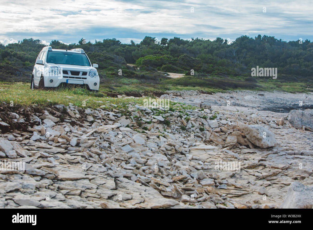 white suv between rocks. off road car travel concept. summer vacation ...