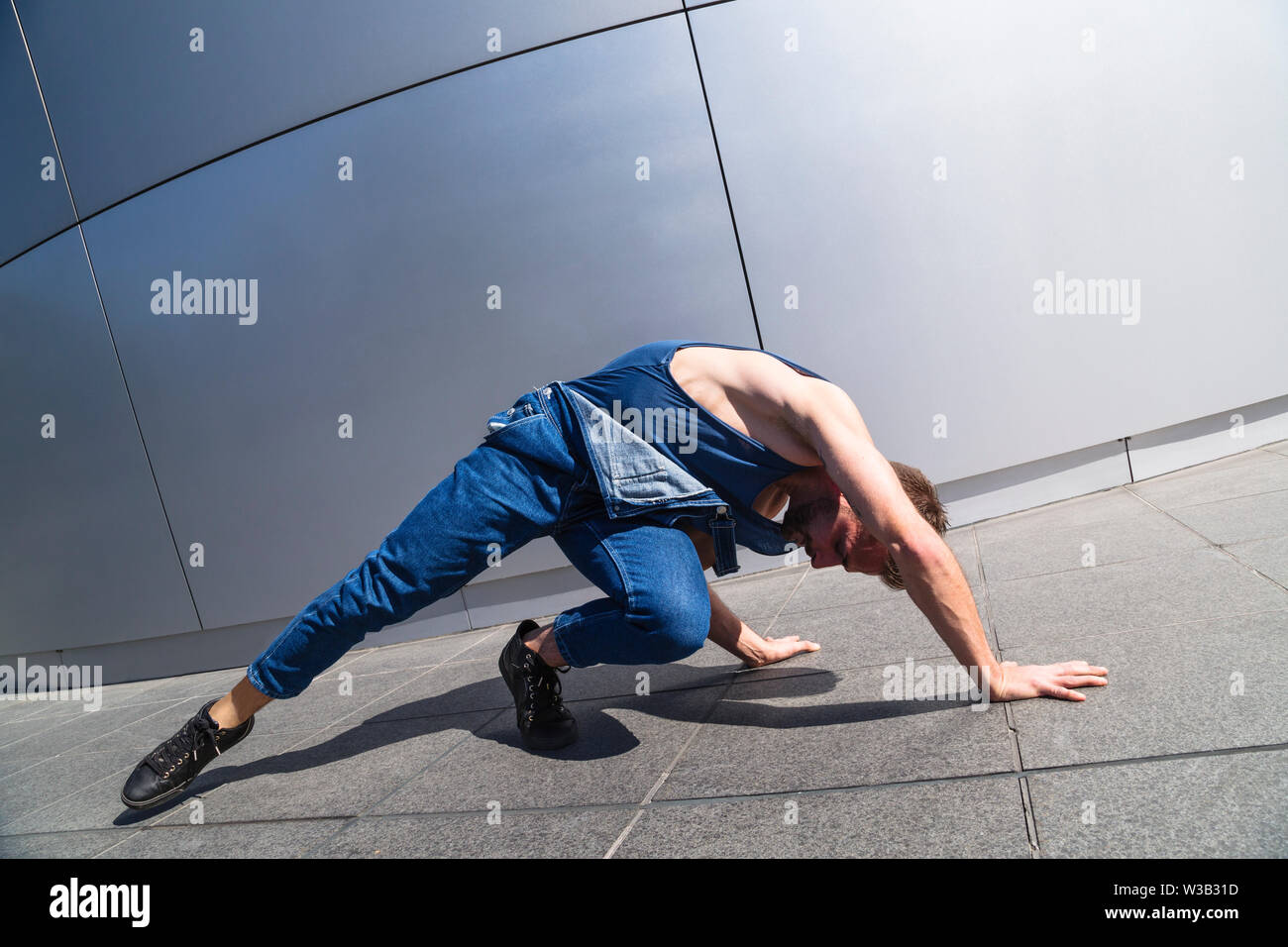 Contemporary dancer dancing on gray stone floor Stock Photo - Alamy