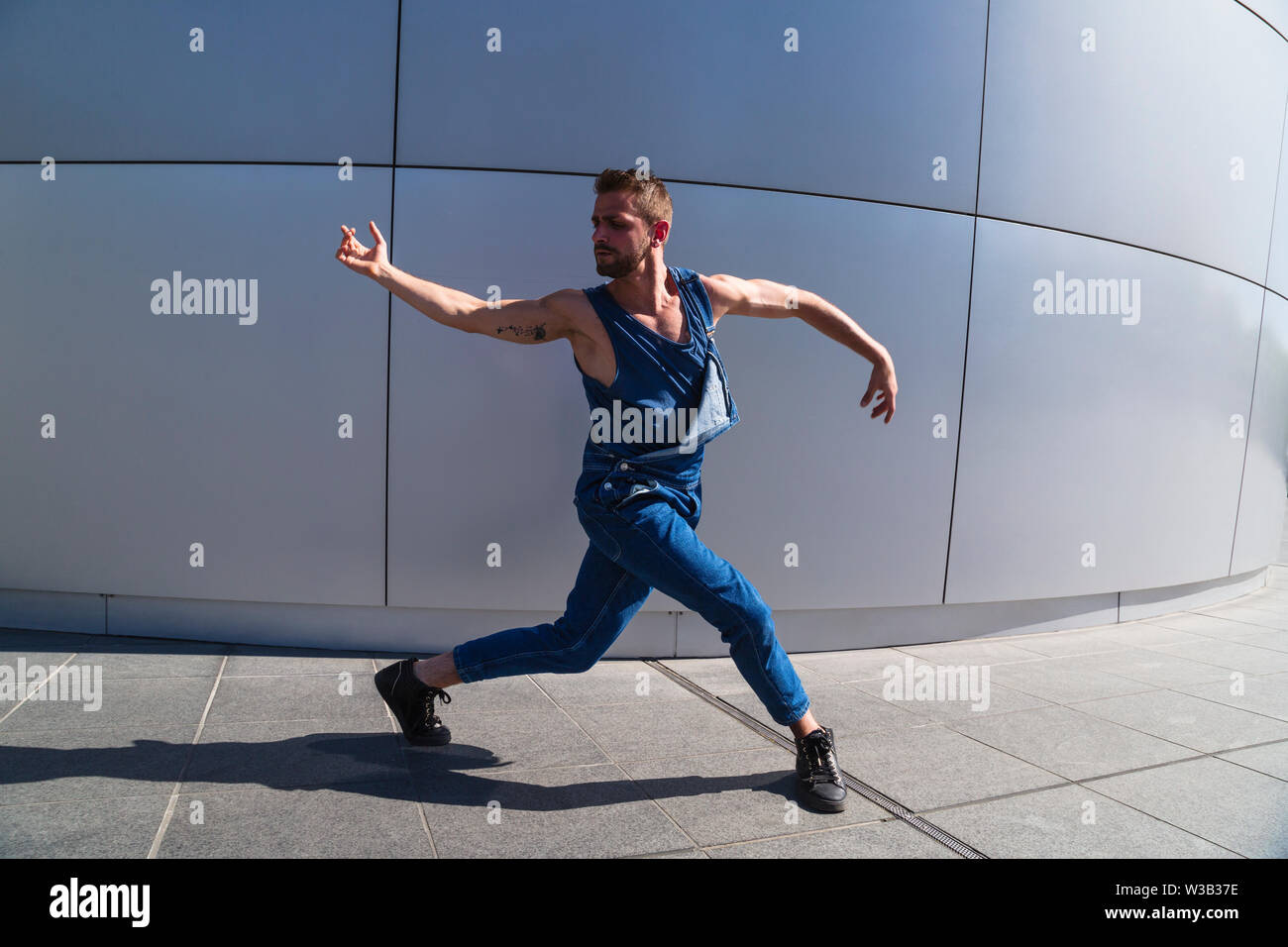 Young dancer practising dance motion on street Stock Photo - Alamy