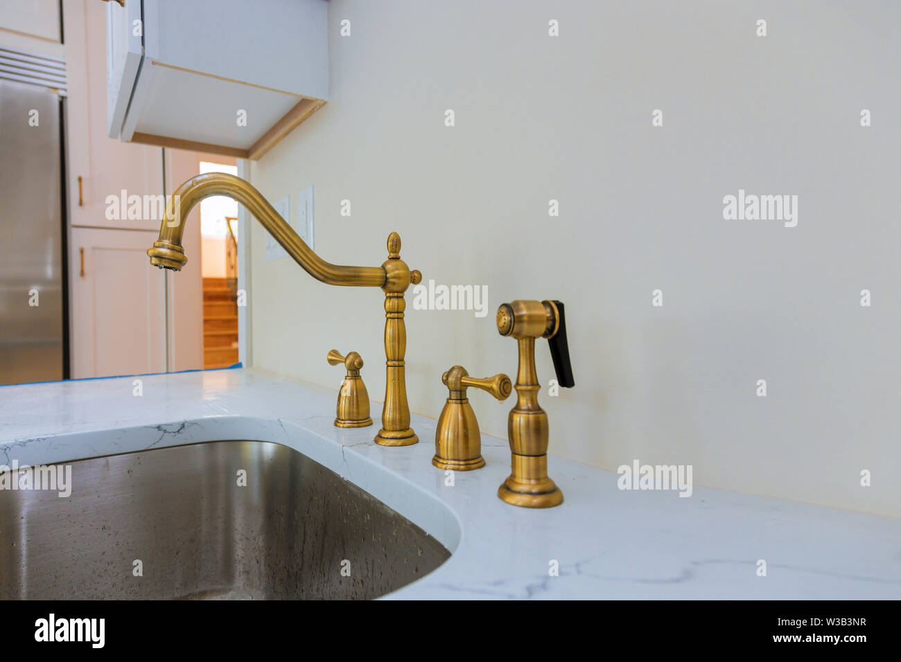 New modern white kitchen with built in chrome water tap Stock Photo - Alamy