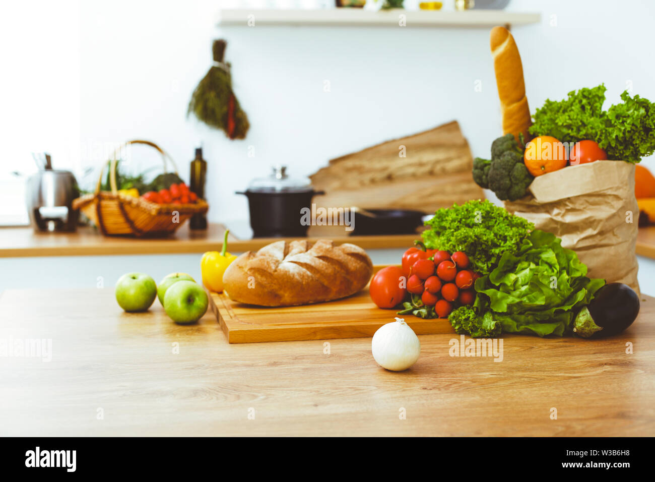 Desk with many fresh vegetables and fruits in the kitchen. Cooking ...