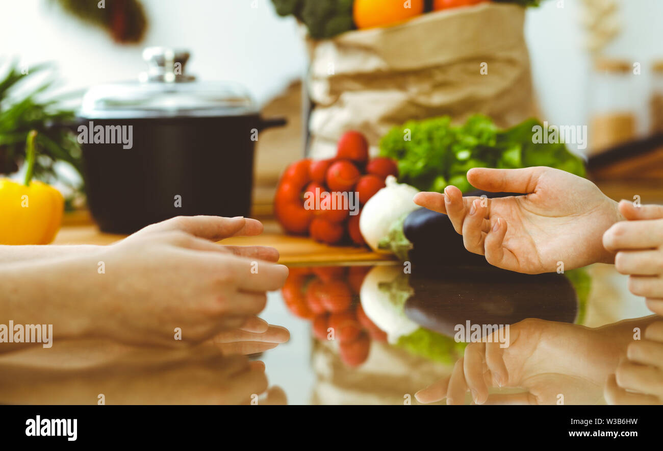 Closeup of human hands discussing something while cooking in kitchen ...