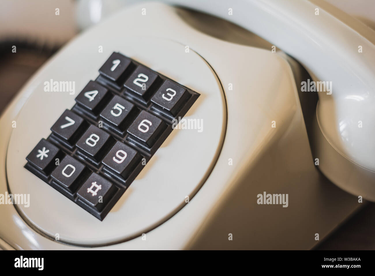Closeup image of an old vintage telephone with black buttons and ...