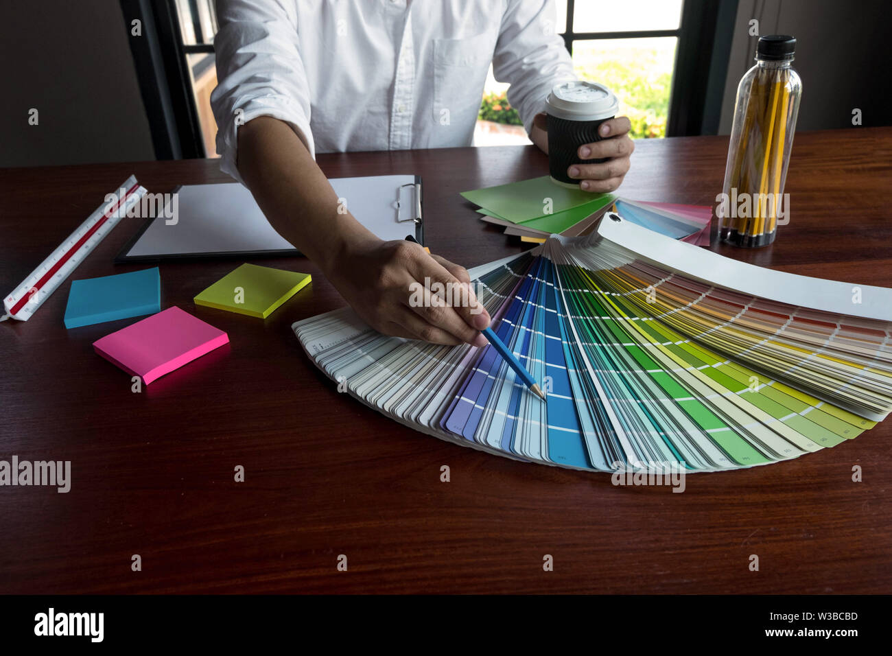 Graphic designer choose colors from the color bands samples for design ...