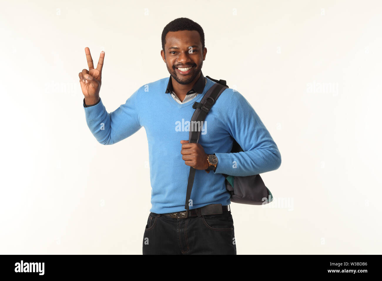 Portrait of a college student smiling and showing V sign Stock Photo ...