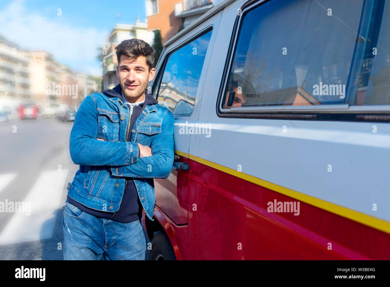 Man standing next to van Stock Photo - Alamy