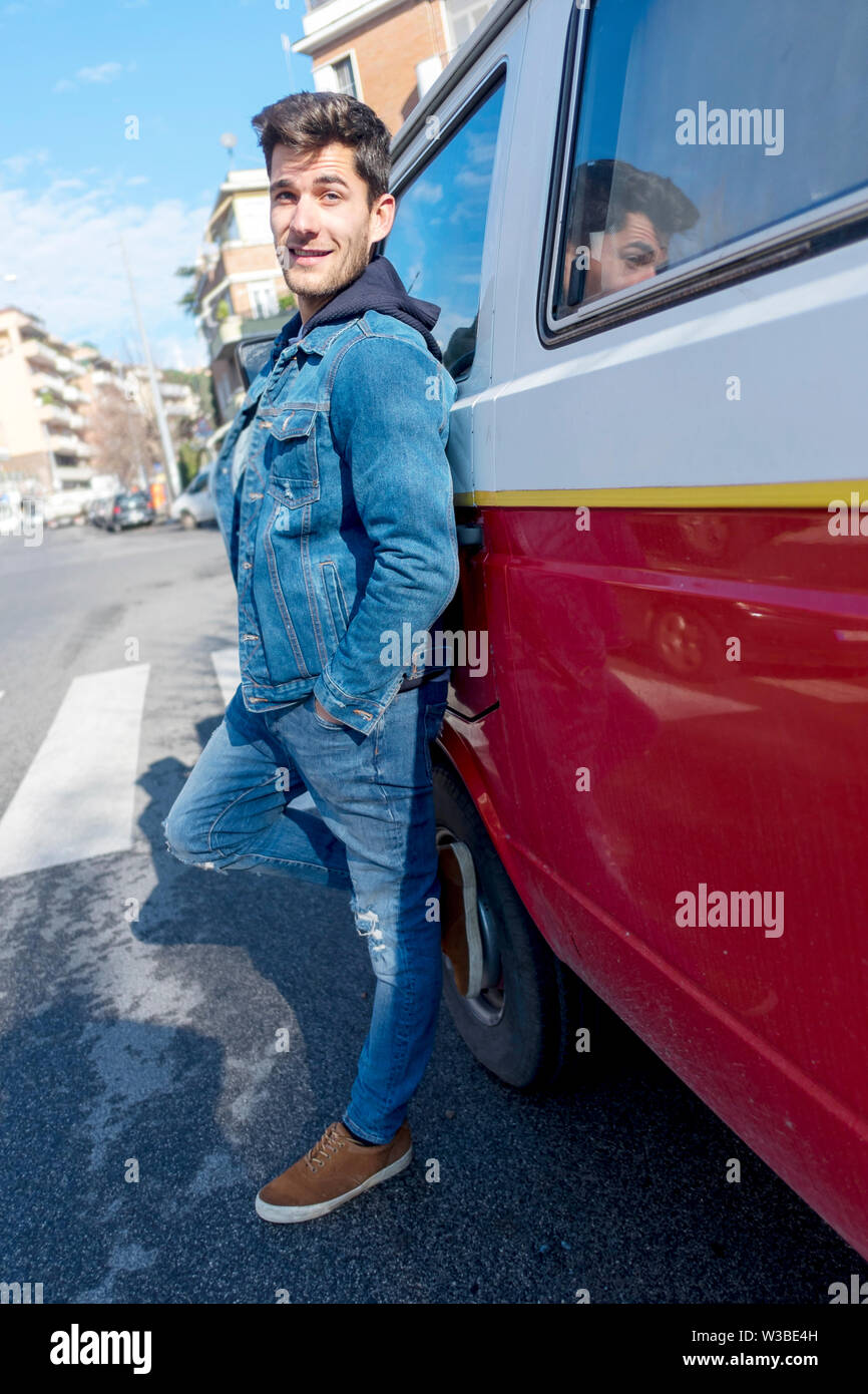 Man standing next to van Stock Photo - Alamy