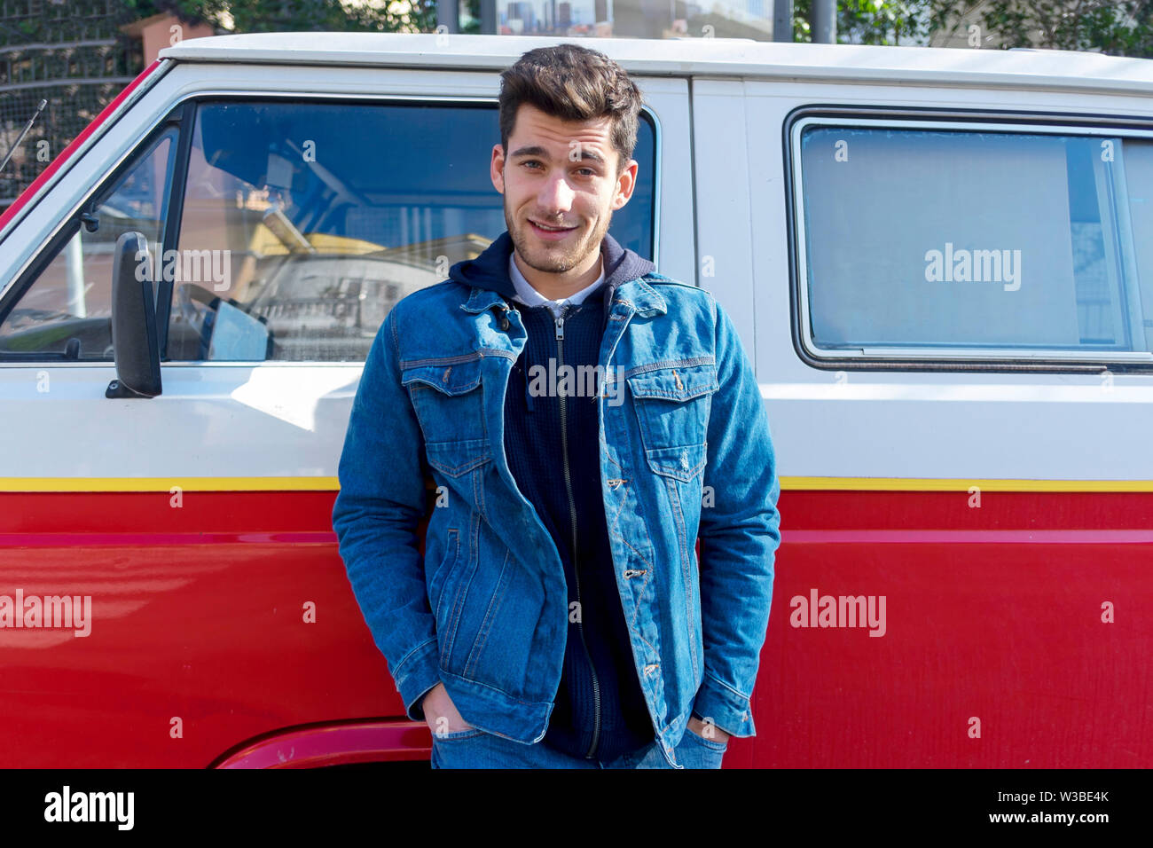 Man standing next to van Stock Photo - Alamy
