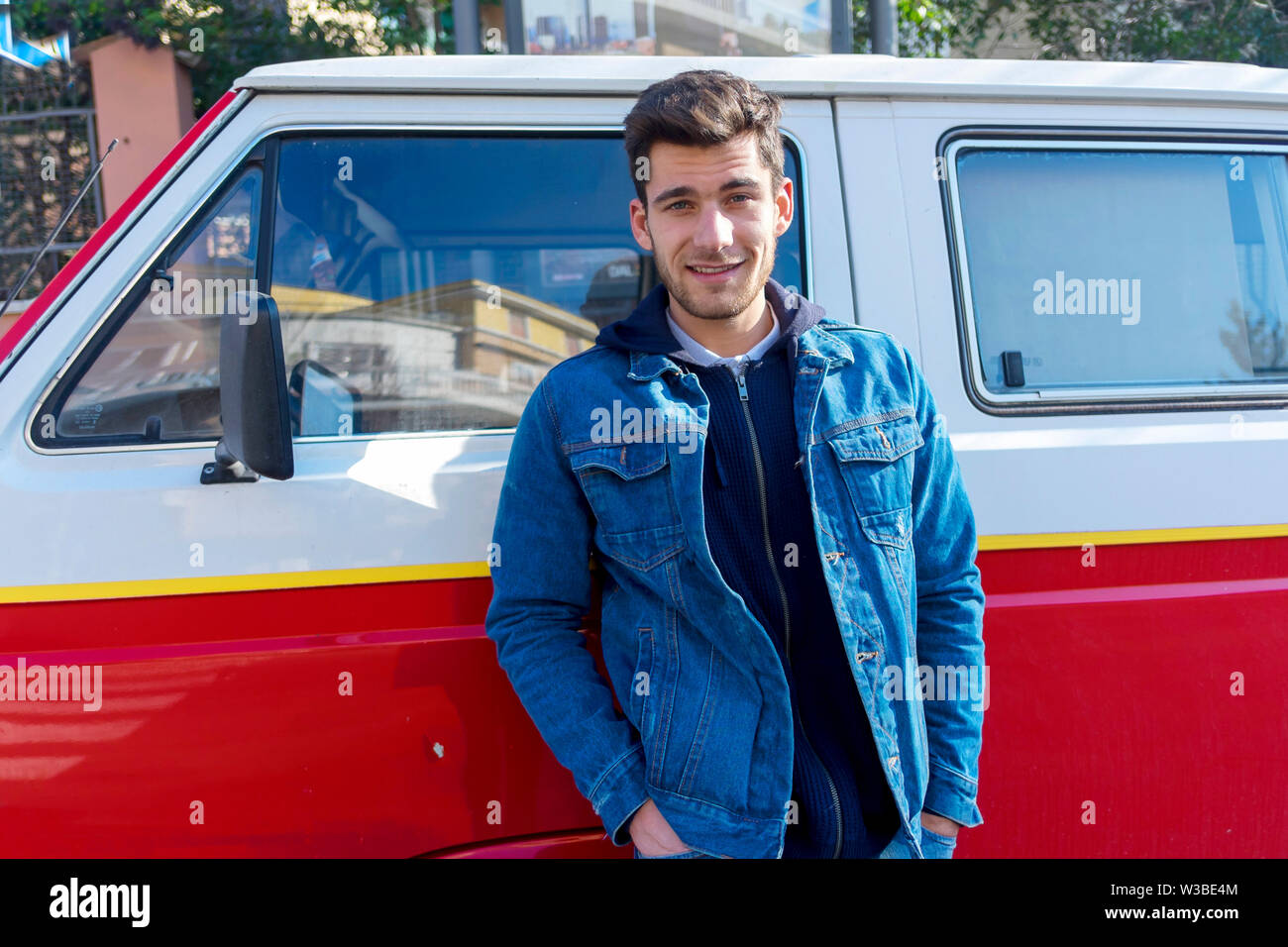 Man standing next to van Stock Photo - Alamy