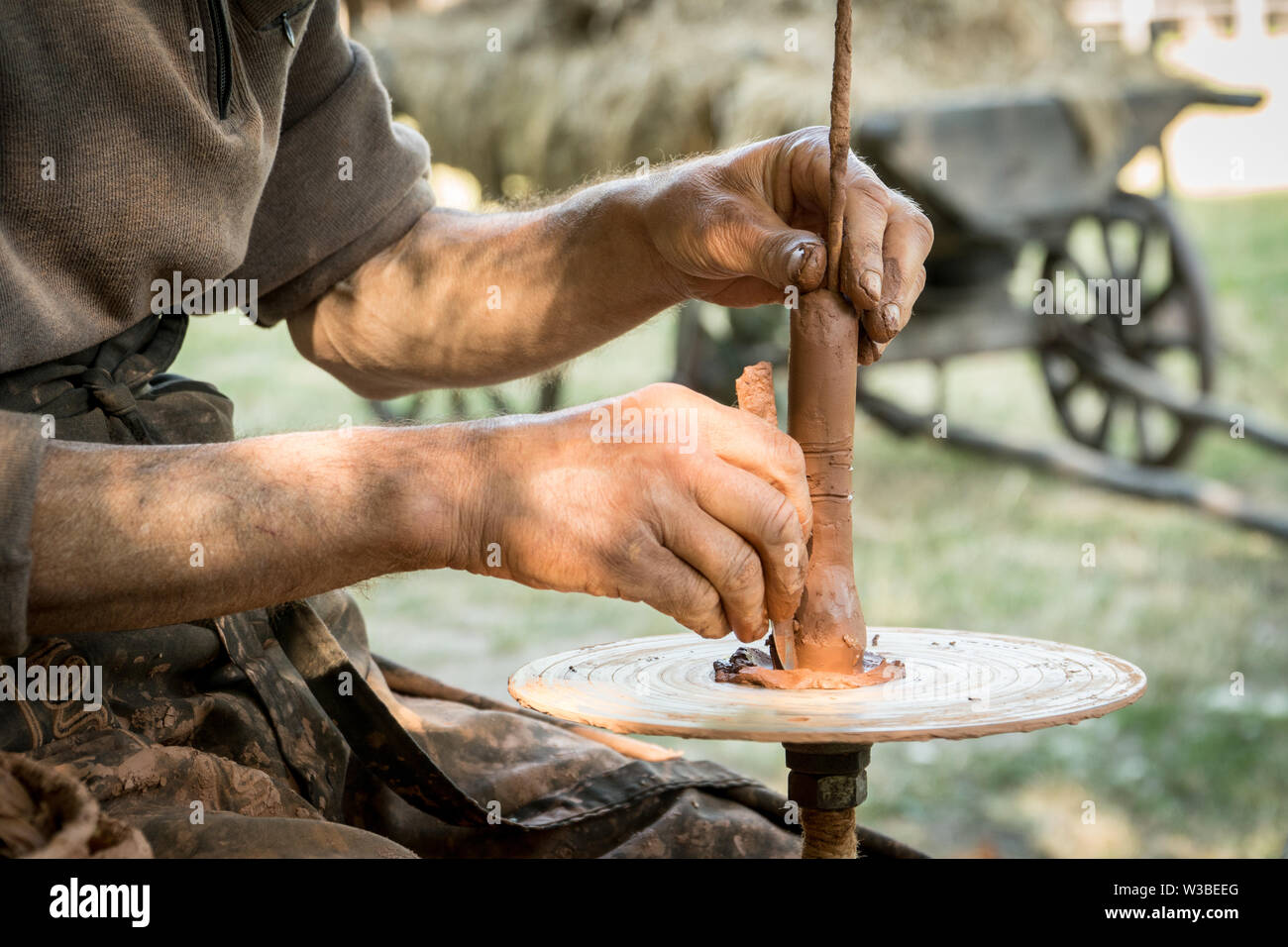 Hands of a artisan creating new clay shape from brown clay. Handicraft ...