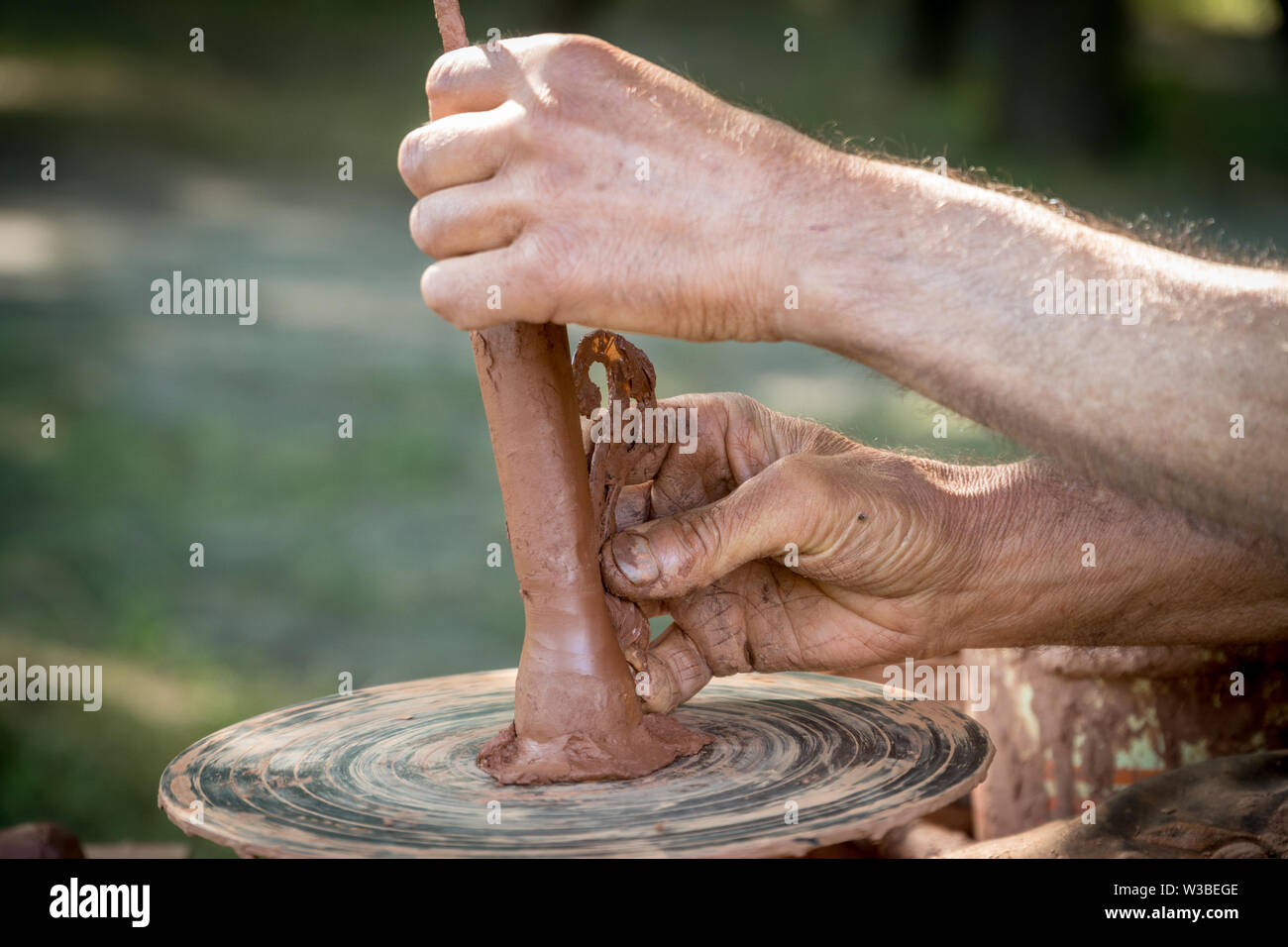 Hands of a artisan creating new clay shape from brown clay. Handicraft ...