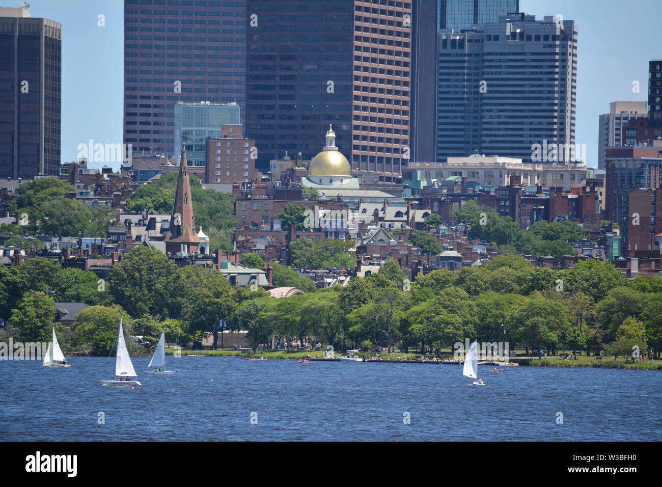 Sailboats sailing in the Charles River Basin with the Boston skyline ...