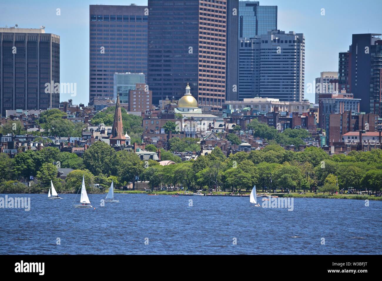 Sailboats sailing in the Charles River Basin with the Boston skyline ...