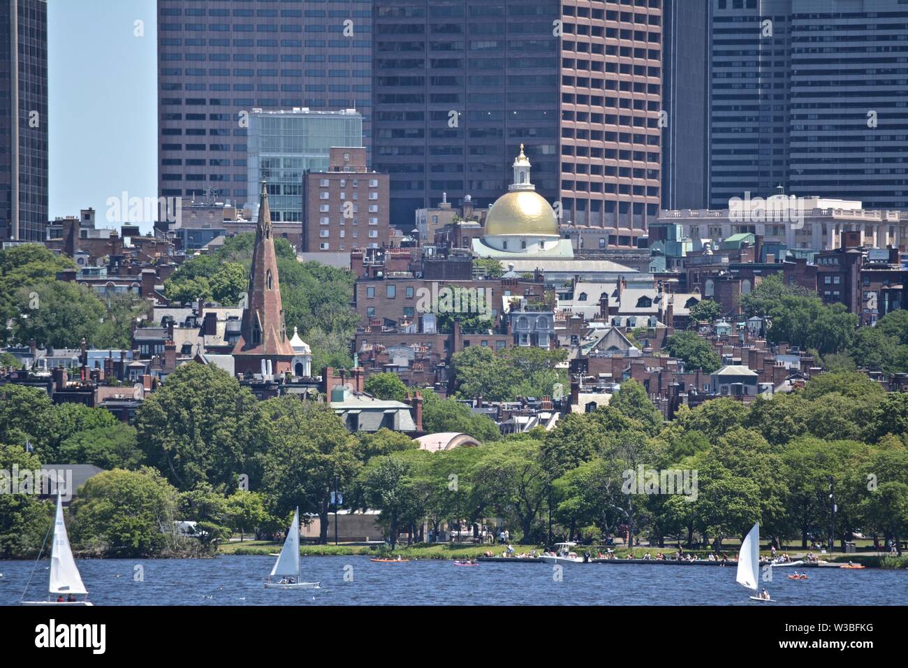 Sailboats sailing in the Charles River Basin with the Boston skyline ...