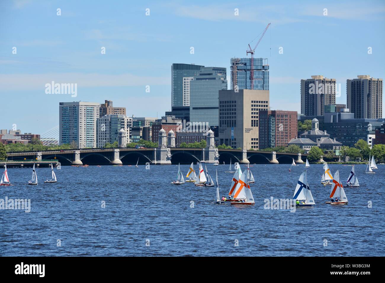 Sailboats sailing in the Charles River Basin with the Boston skyline ...