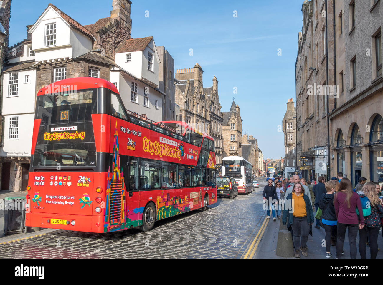 Open top city sightseeing bus on sunny High Street, with beautiful ...