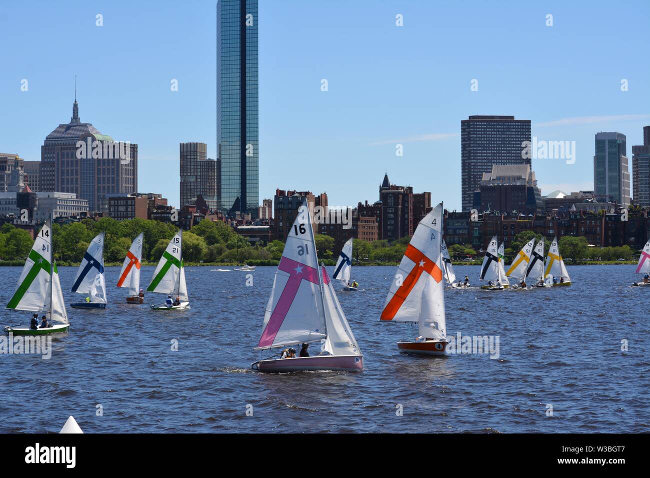 Sailboats sailing in the Charles River Basin with the Boston skyline ...