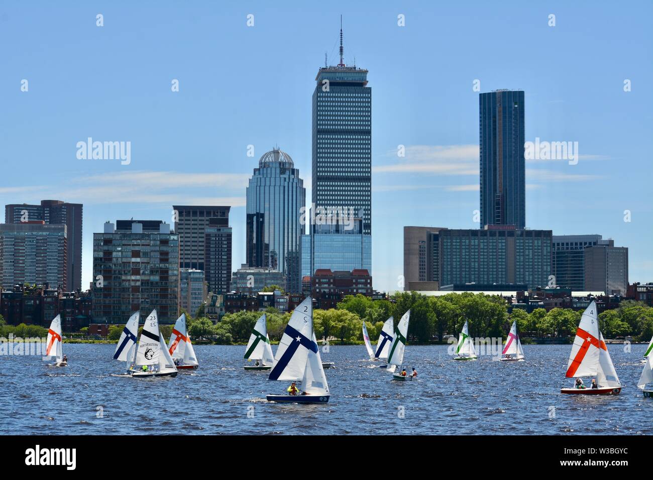 Sailboats sailing in the Charles River Basin with the Boston skyline ...
