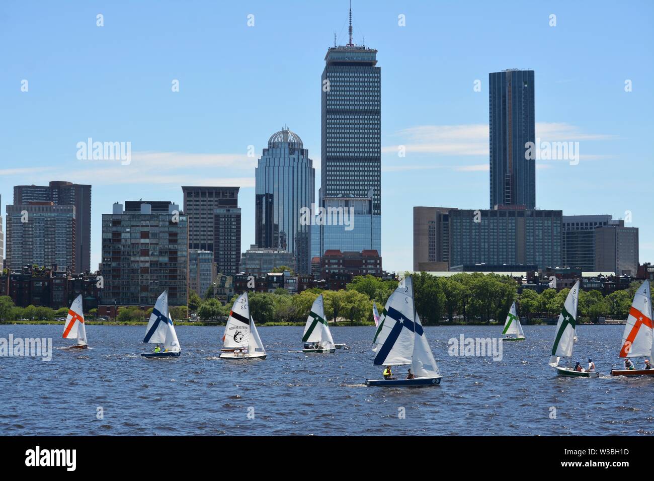 Sailboats sailing in the Charles River Basin with the Boston skyline ...