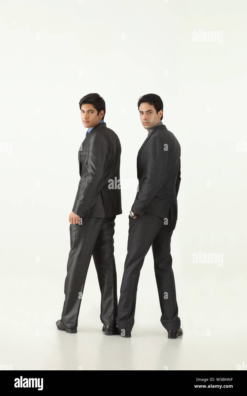 Portrait of two business executives standing side by side Stock Photo ...