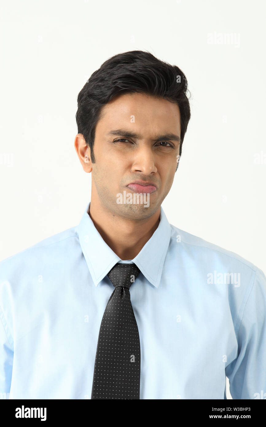 Portrait of an Indian businessman making a face Stock Photo - Alamy