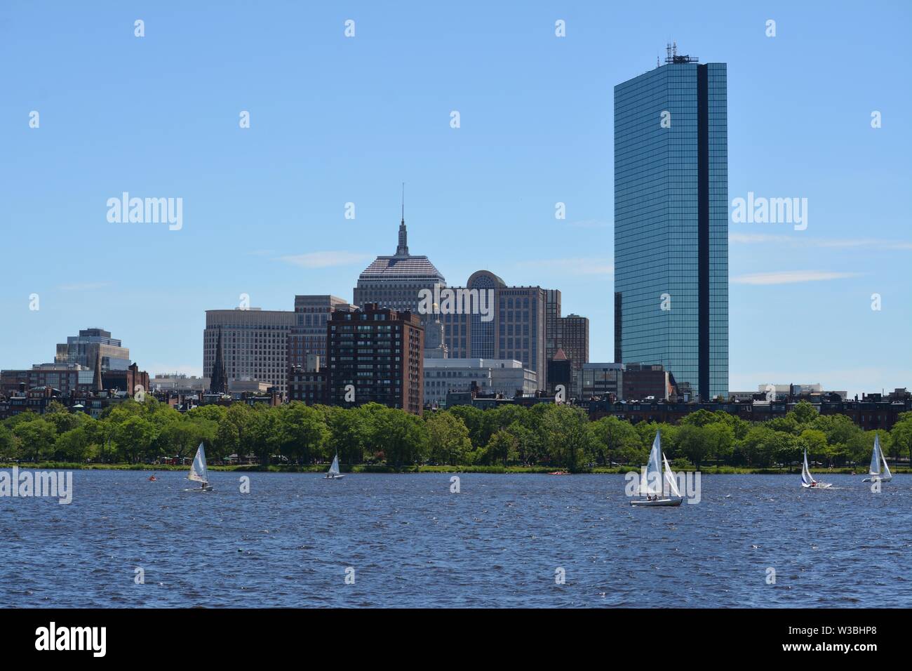Sailboats sailing in the Charles River Basin with the Boston skyline ...
