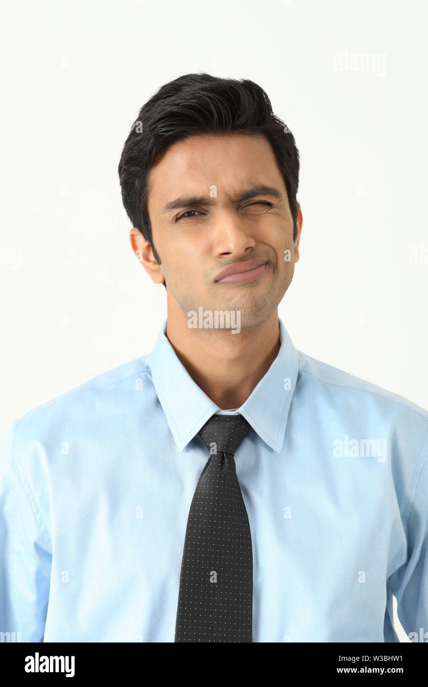 Portrait of an Indian businessman making a face Stock Photo - Alamy