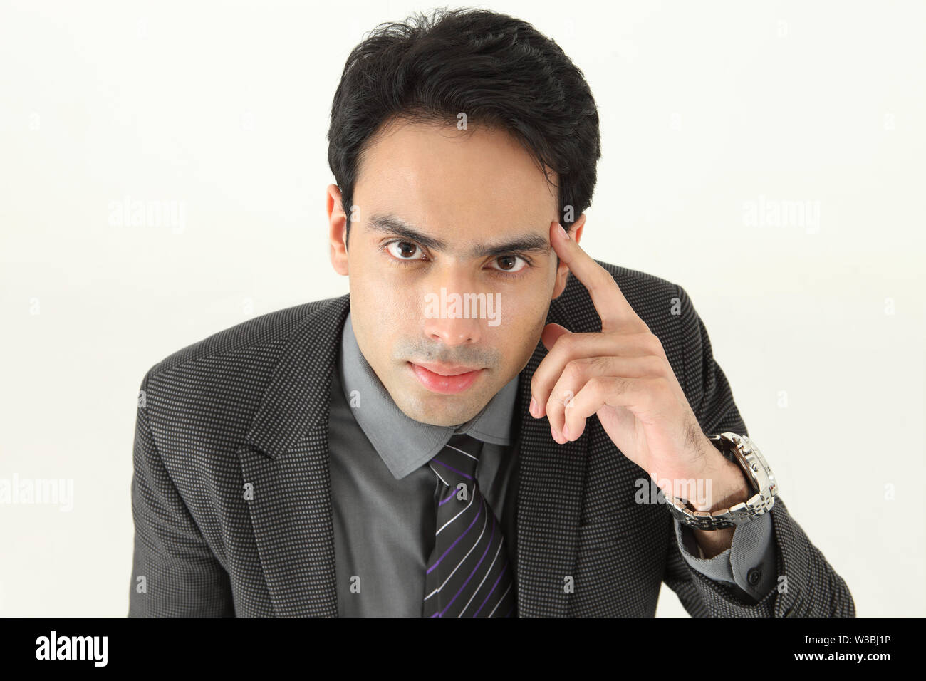 Portrait of an Indian businessman thinking Stock Photo - Alamy