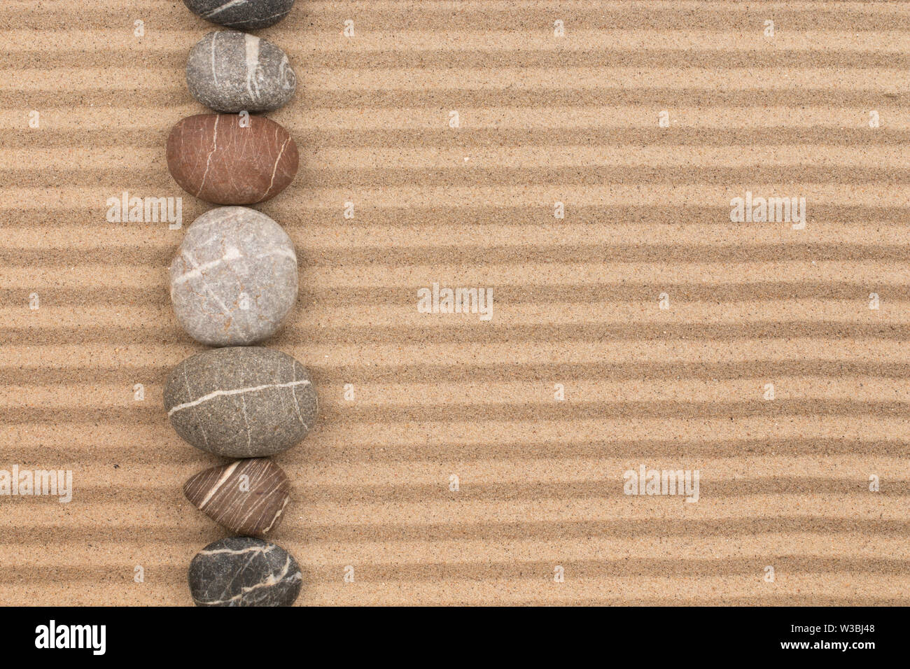 line of striped stones, lies on the lines made of sand. With space for ...