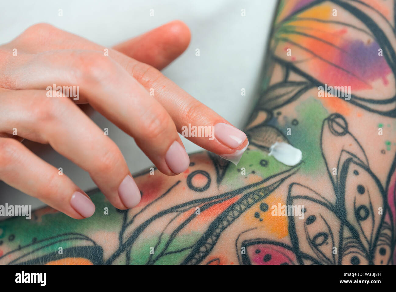 Fingers apply cream to skin. Close up Stock Photo - Alamy