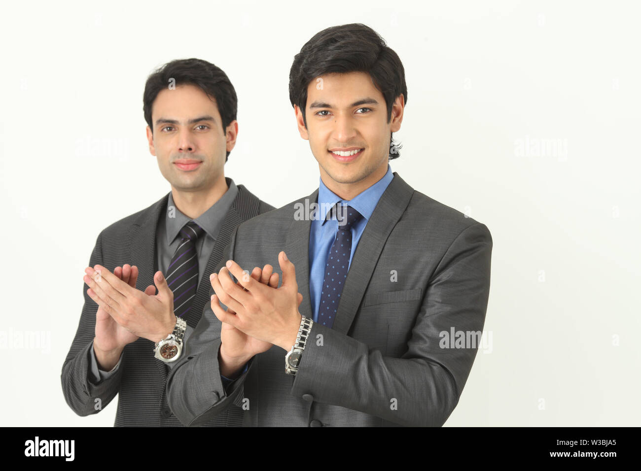 Two businessmen clapping Stock Photo - Alamy
