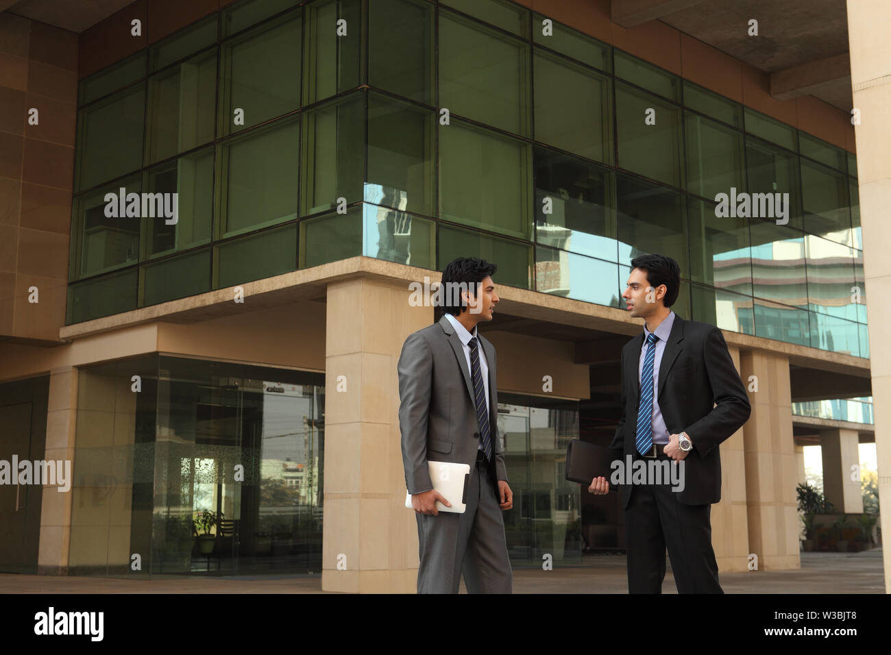 Two business executives discussing in an office Stock Photo - Alamy