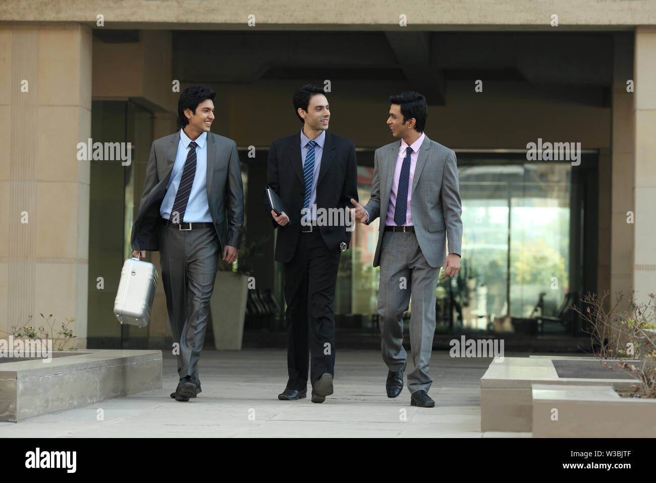 Three business executives discussing in an office Stock Photo - Alamy