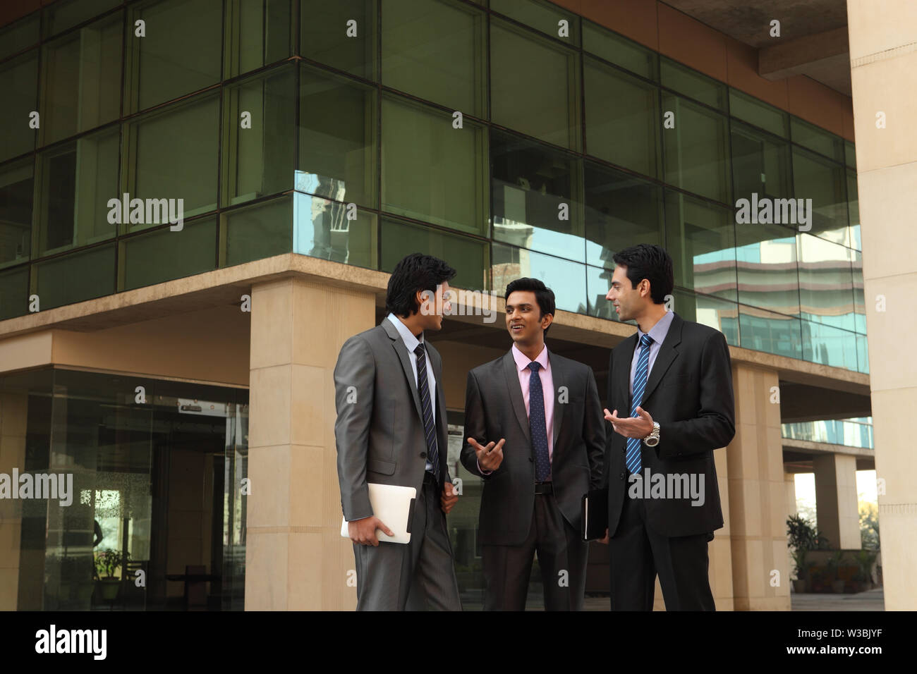 Three business executives discussing in an office Stock Photo - Alamy